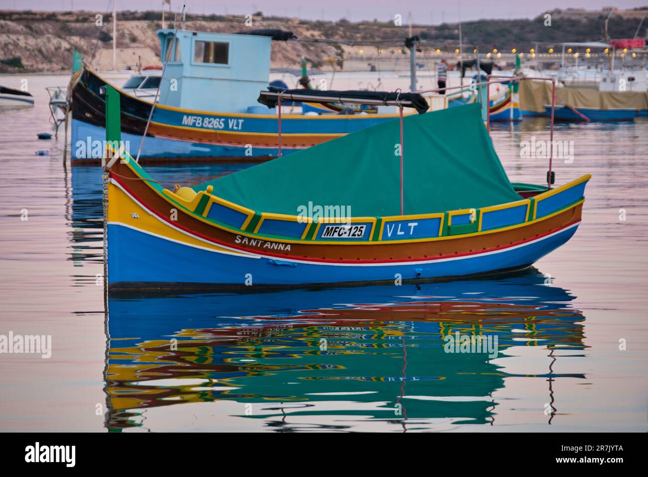 Traditional colourful Maltese fishing boats mooring in the harbour ...