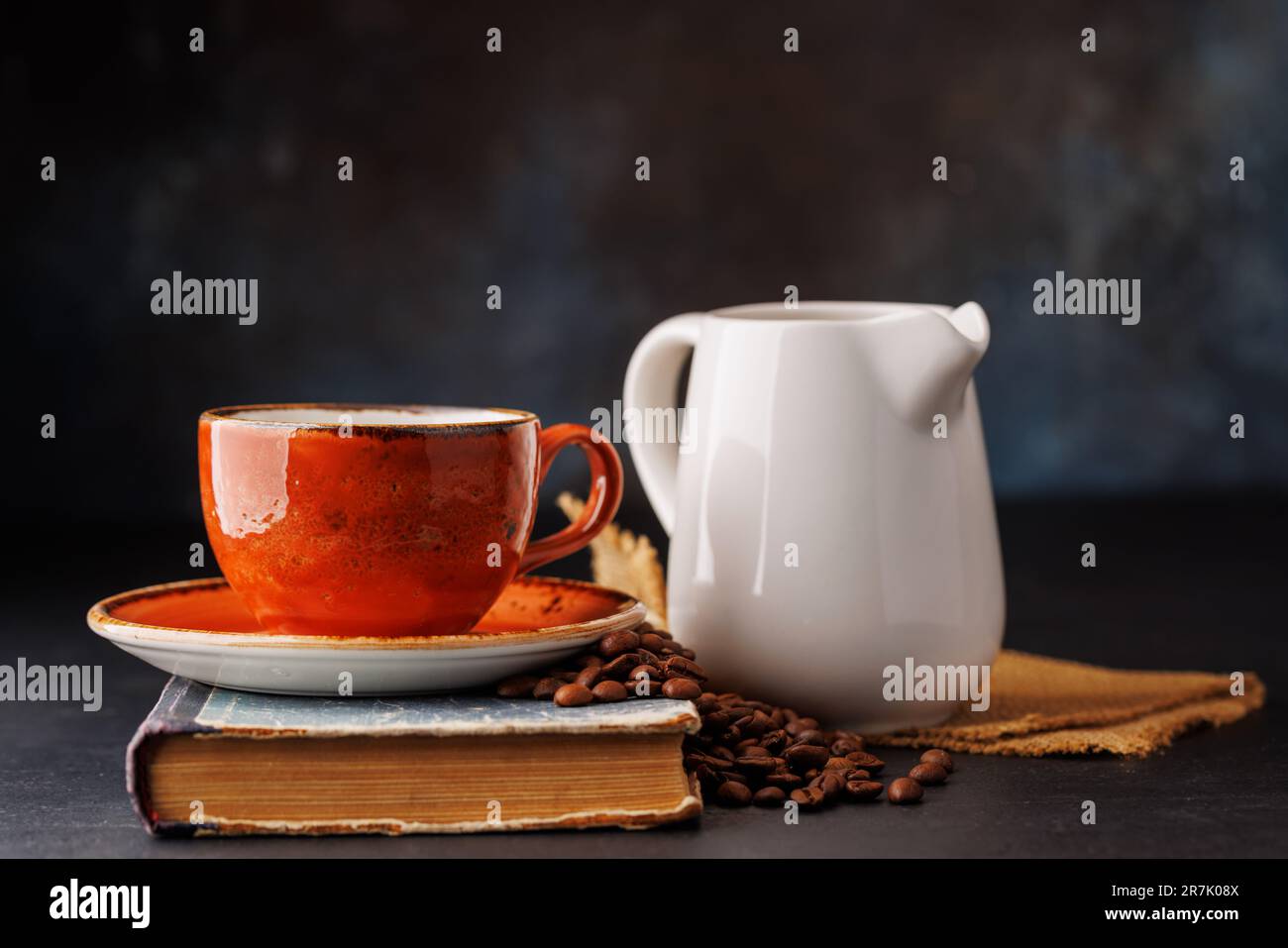 Rich coffee in a cup with aromatic roasted beans, a perfect morning ...