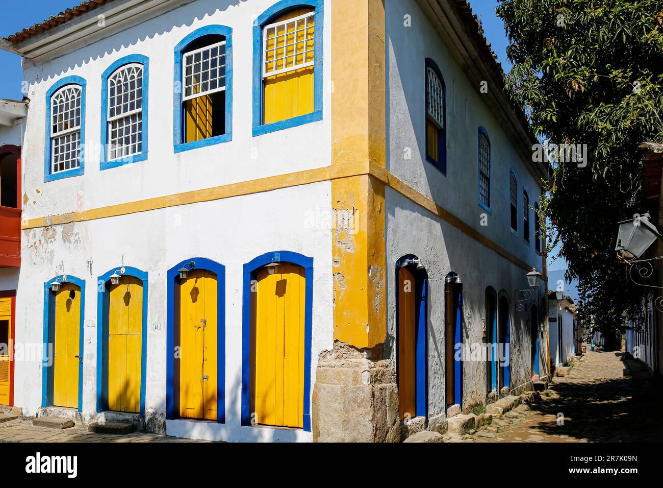 Corner of a two story colonial house with colorful facade in the late ...