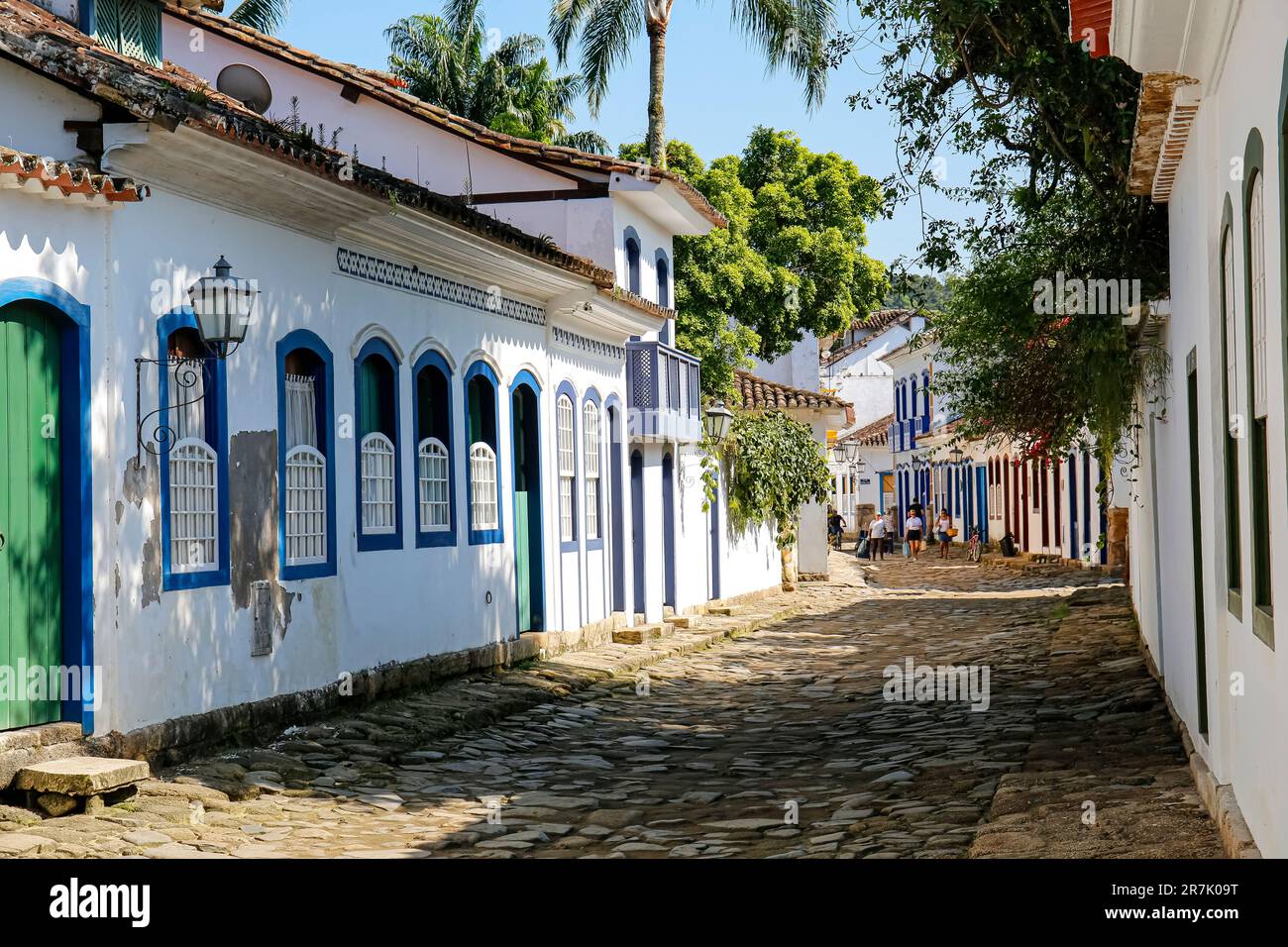 View into typical narrow cobblestone street with colonial buildings ...