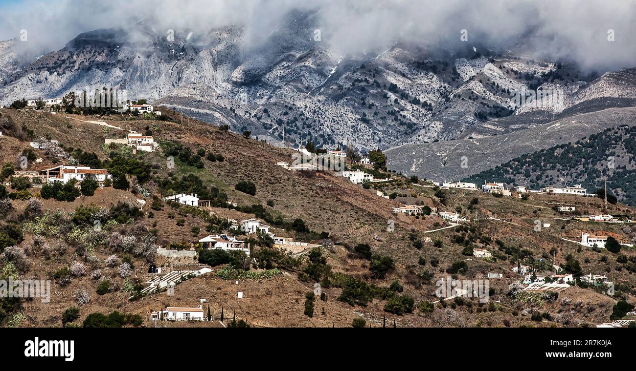 An aerial shot of the landscape of a village nestled on the side of a ...