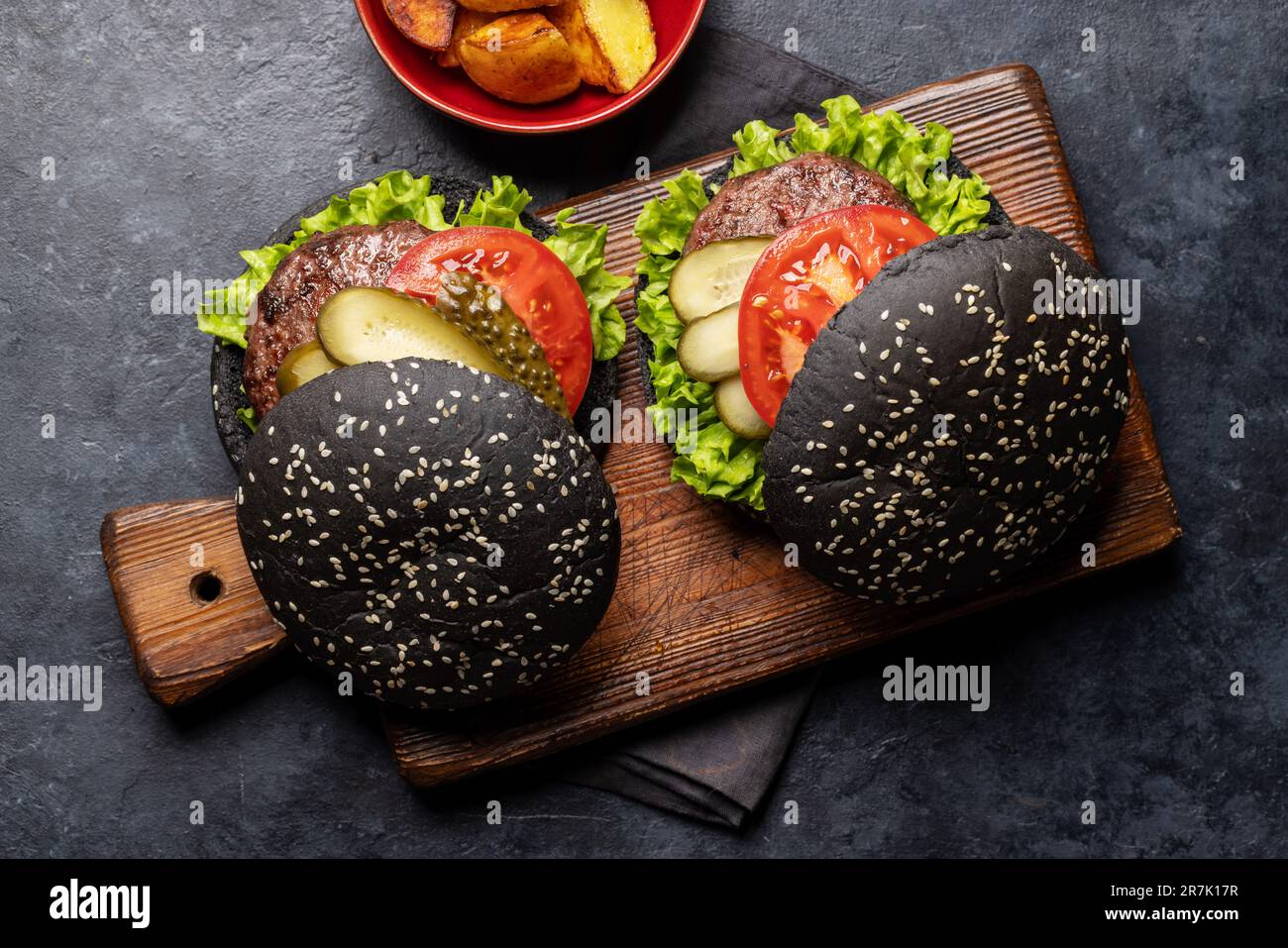 Homemade beef burgers with black buns and french fries. Flat lay Stock ...