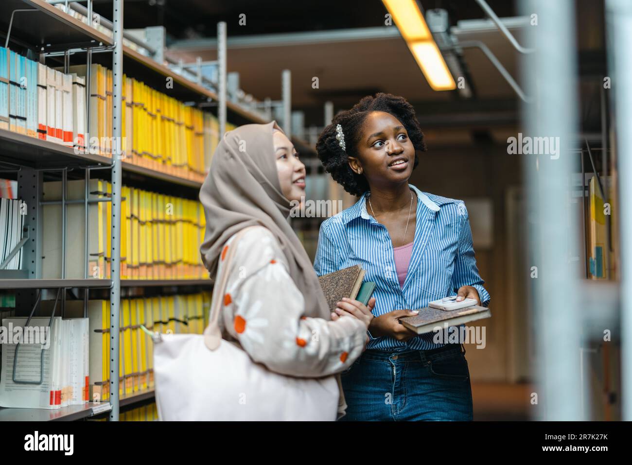 University female bookshelf hi-res stock photography and images - Alamy
