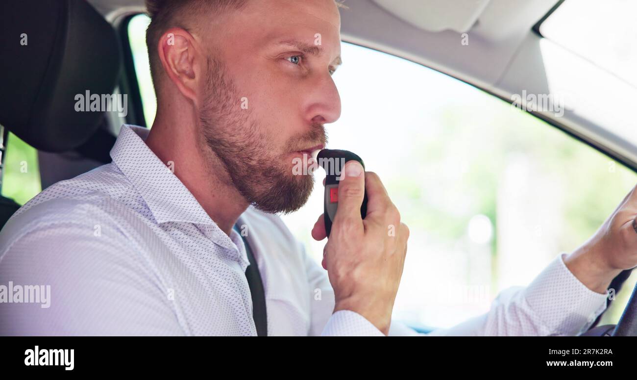 Breathalyzer Alcohol Test In Car. Man Taking Breath Test Stock Photo ...