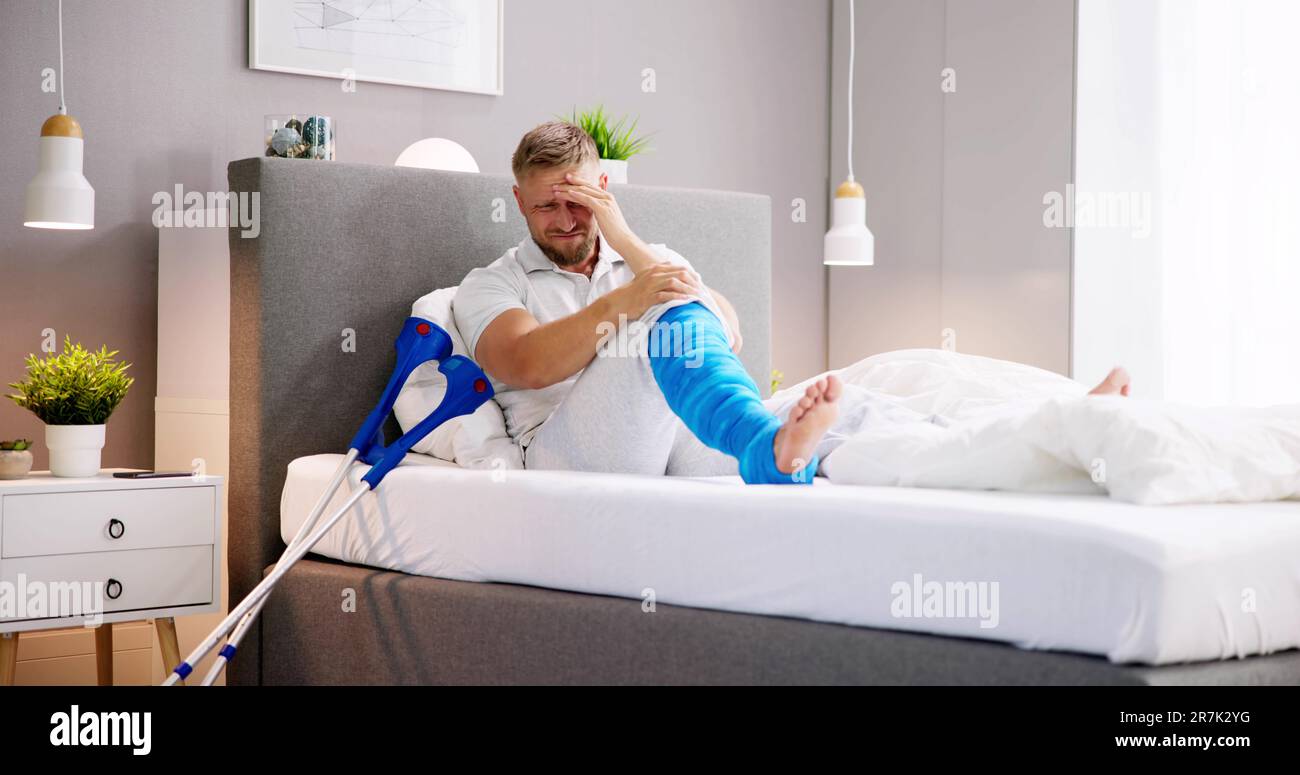 Man With Broken Leg Fracture Injury And Cast Using Crutches Stock Photo ...