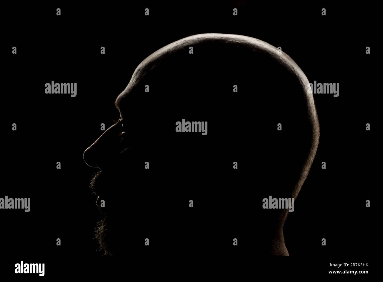 Silhouette of a man head in backlight. Low light portrait. Isolated on ...