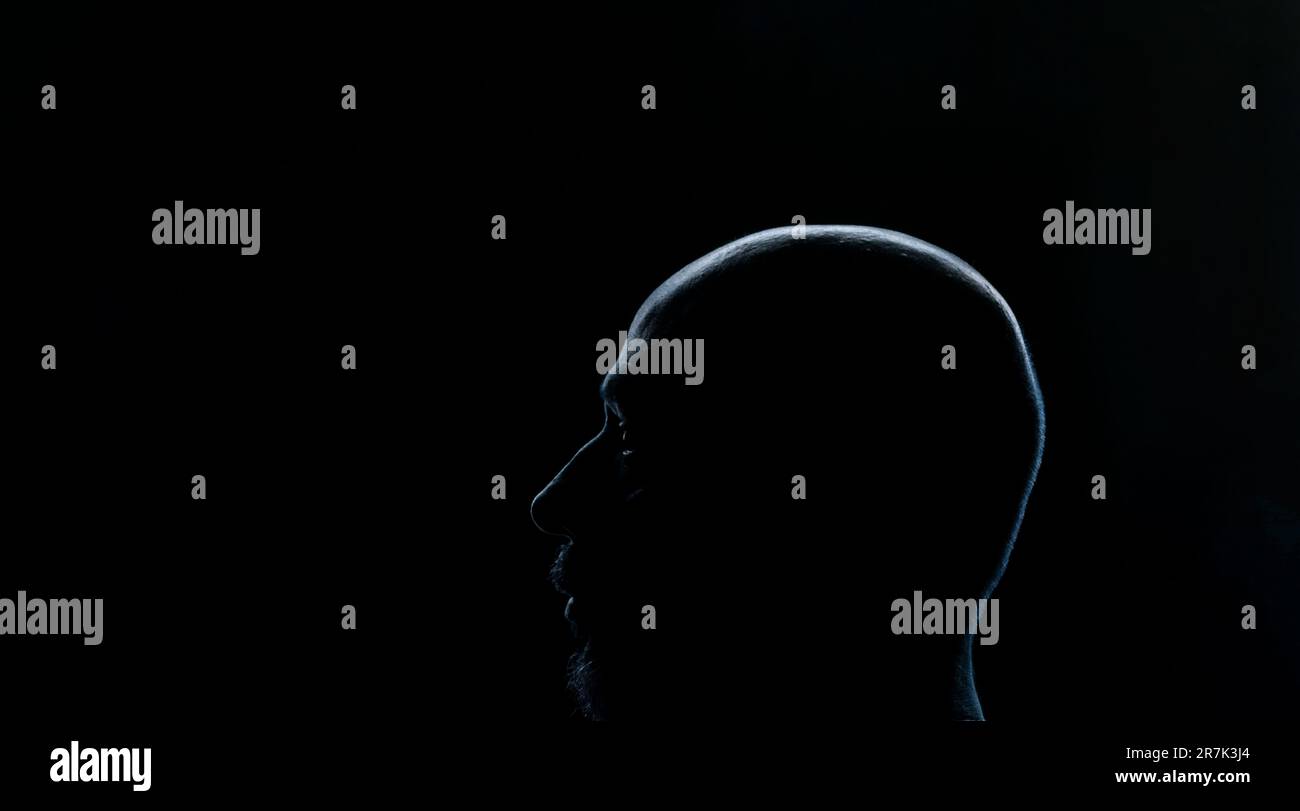 Silhouette of a man head in backlight. Studio portrait. Isolated on ...