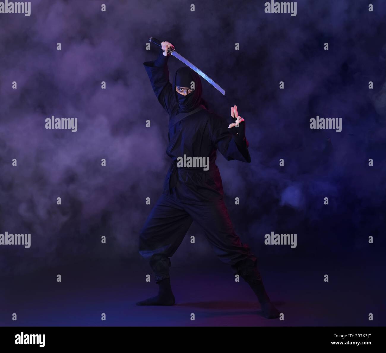 Male ninja with sword on dark background Stock Photo - Alamy
