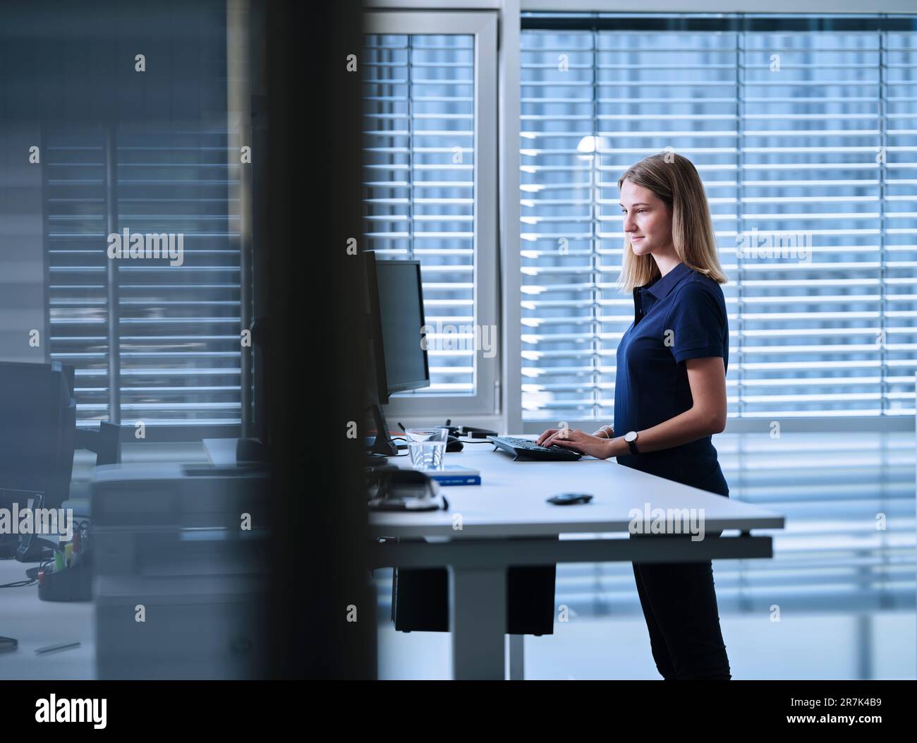 Engineer using computer on desk at factory office Stock Photo - Alamy