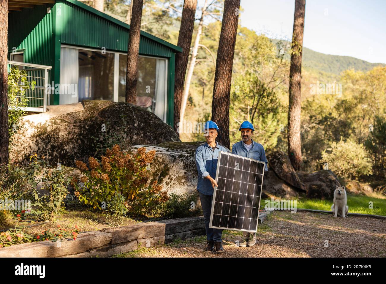 Photovoltaic technicians carrying solar panel together Stock Photo - Alamy