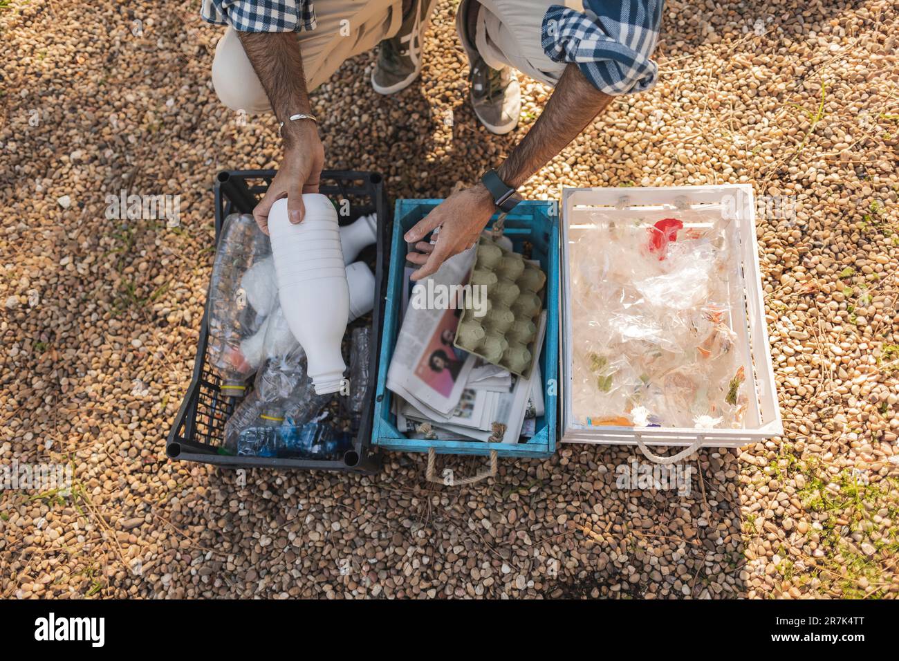 Elevated view of man separating waste in crates Stock Photo - Alamy