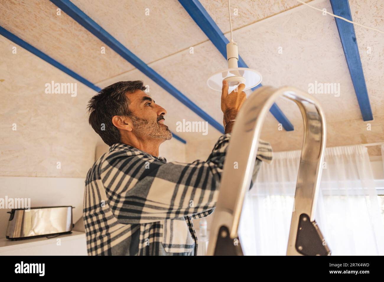 Man standing on ladder hi-res stock photography and images - Alamy