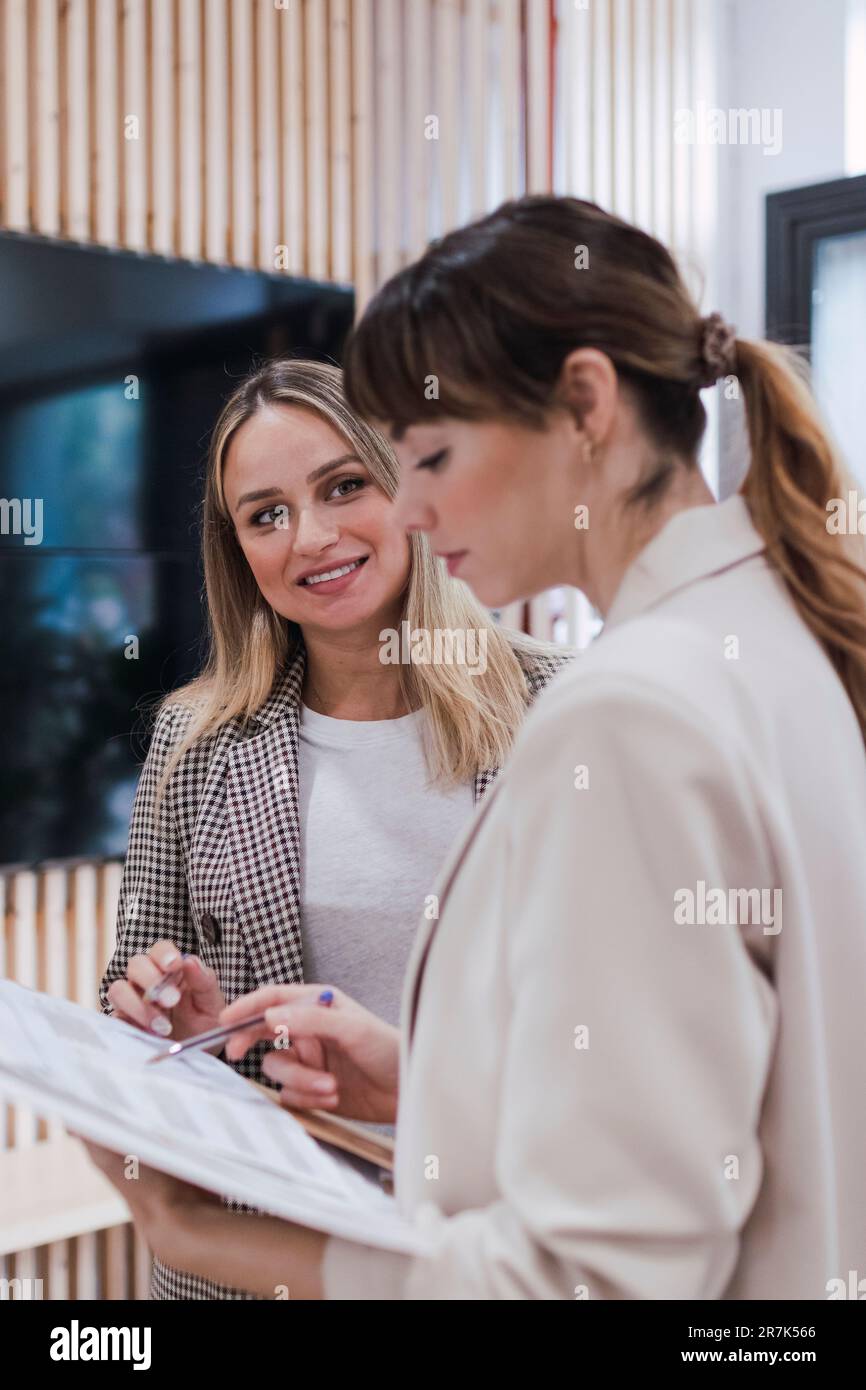 Two young people looking documents hi-res stock photography and images ...