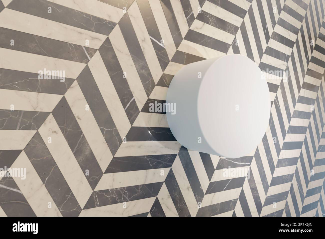 A white circular chair on a checkered wall design Stock Photo - Alamy