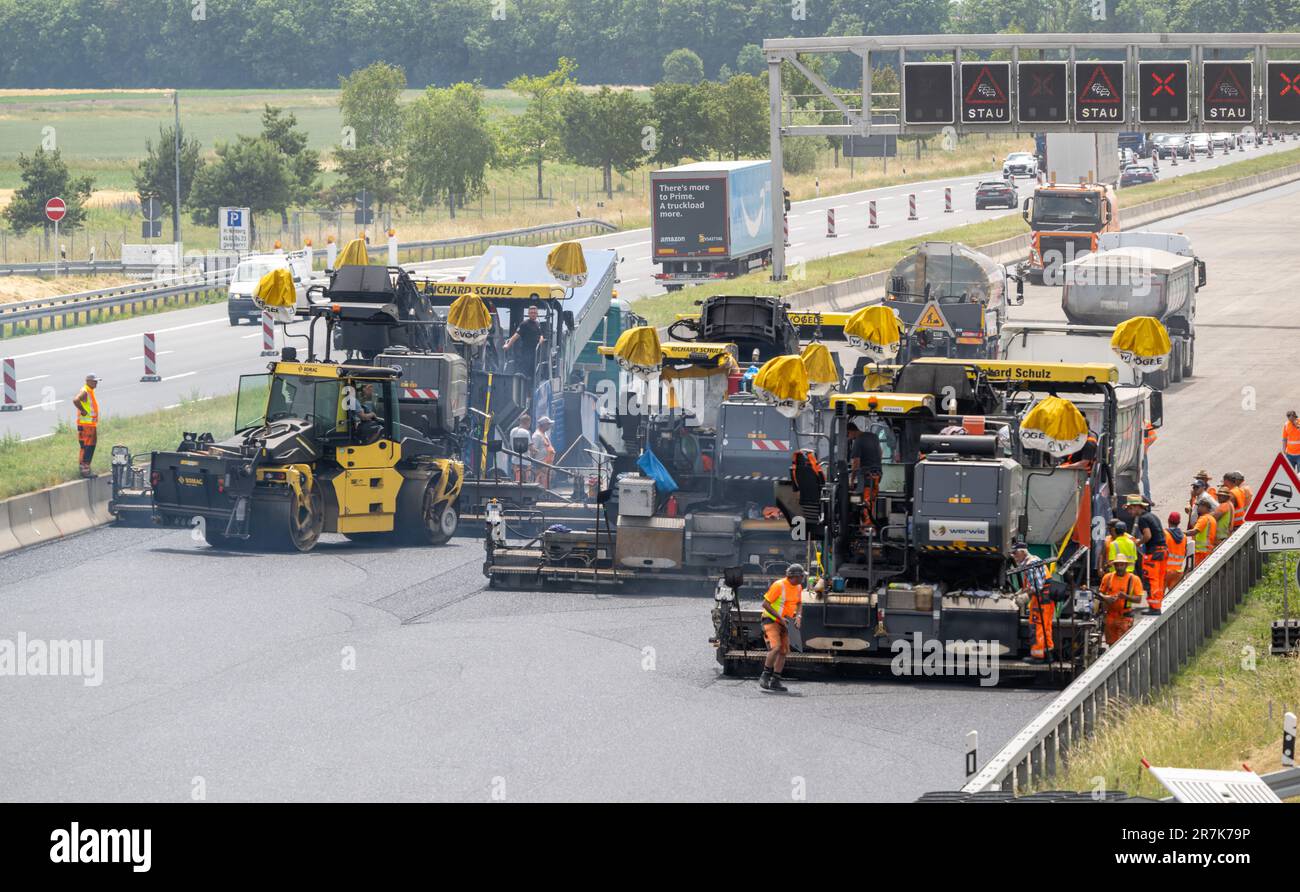 Munich, Germany. 16th June, 2023. Workers use large road construction ...