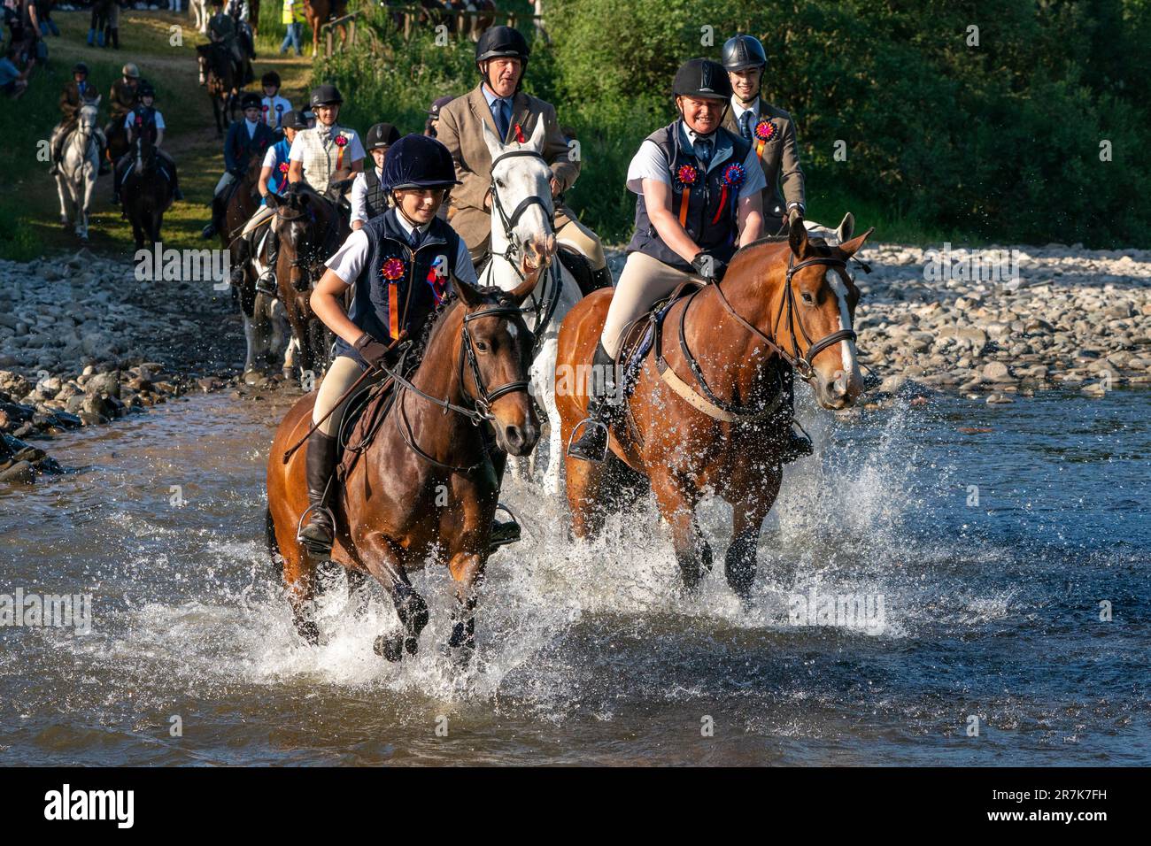 Riders ford the River Ettrick during the Selkirk Common Riding, a ...