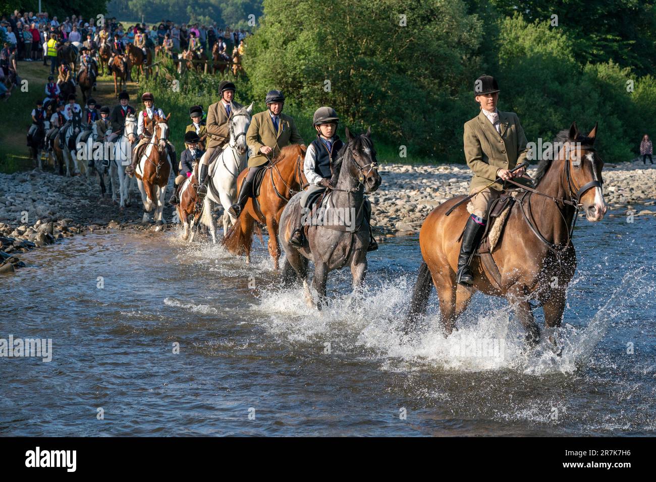 Riders ford the River Ettrick during the Selkirk Common Riding, a ...