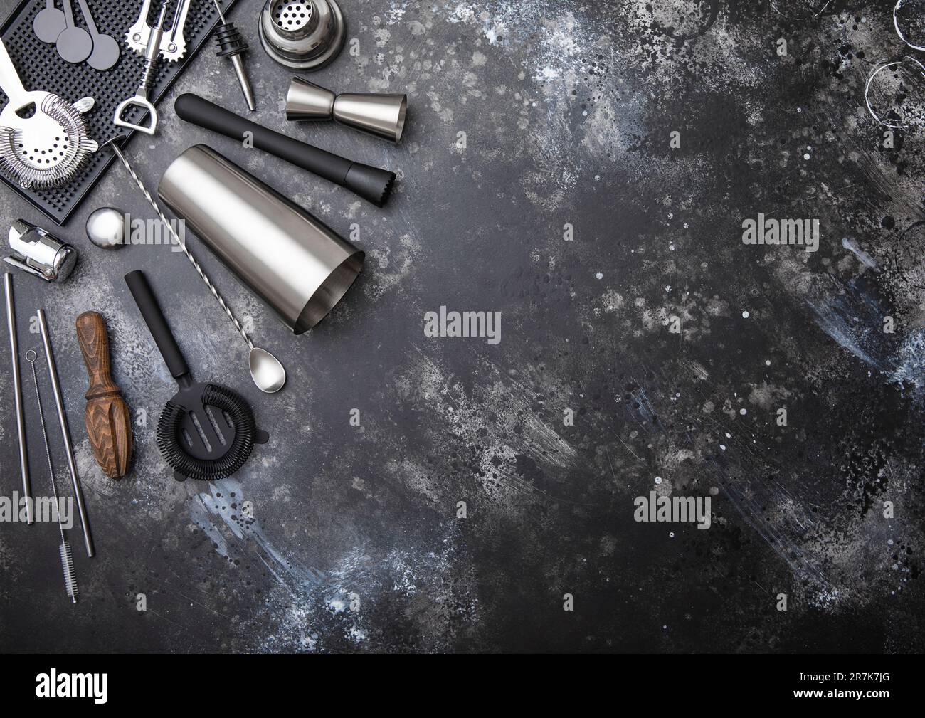 Steel cocktail shaker,strainer,jigger and wooden juicer with muddler on ...