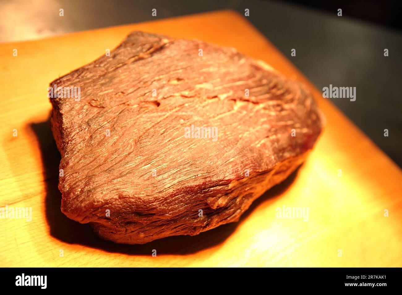 big steak in the kictchen warm light Stock Photo - Alamy