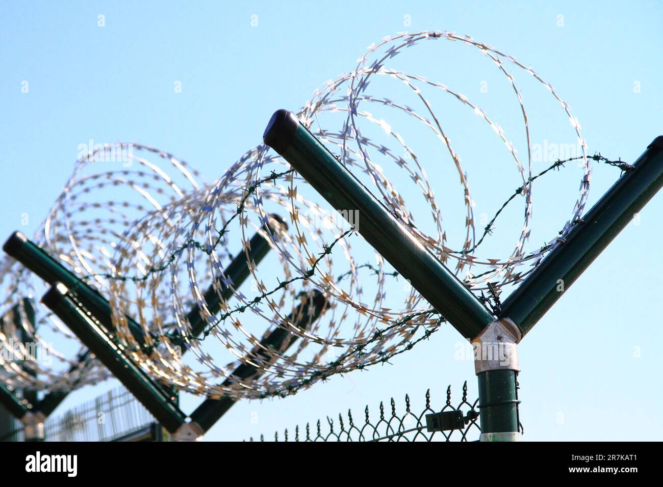 barbed wire against blue sky as nice army background Stock Photo - Alamy