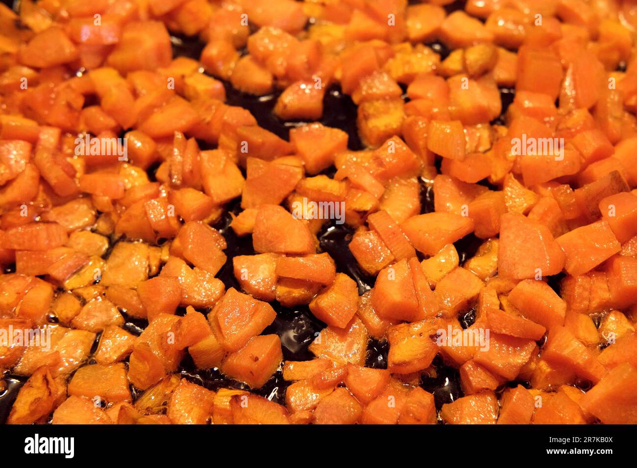 Mixing Chopped Carrots frying in a pan. Fresh juice grated Carrots ...