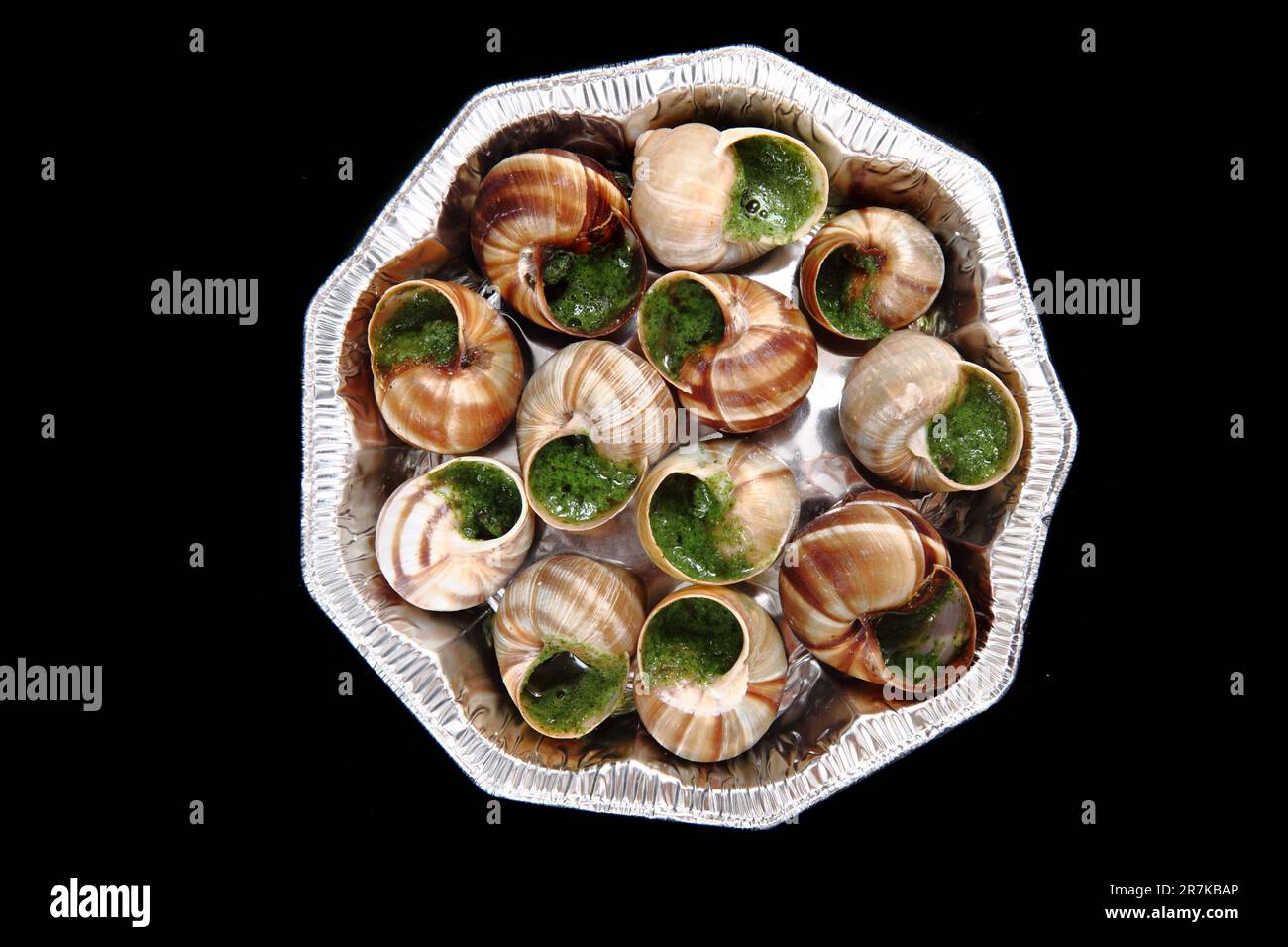 snails (french gourmet food) isolated on the black background Stock ...