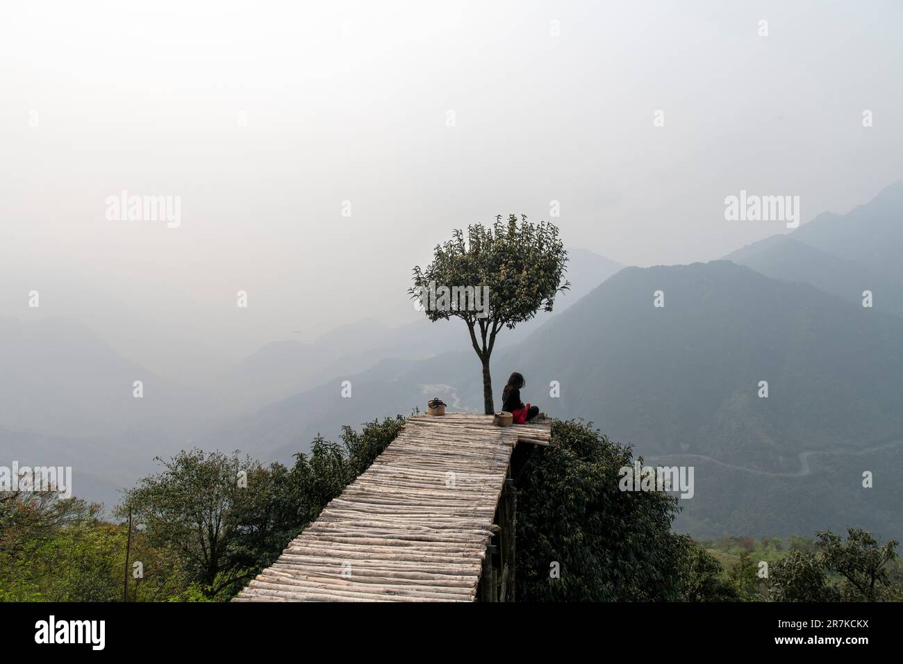 Close up view of a woman sitting on wooden bamboo platform at Sapa ...