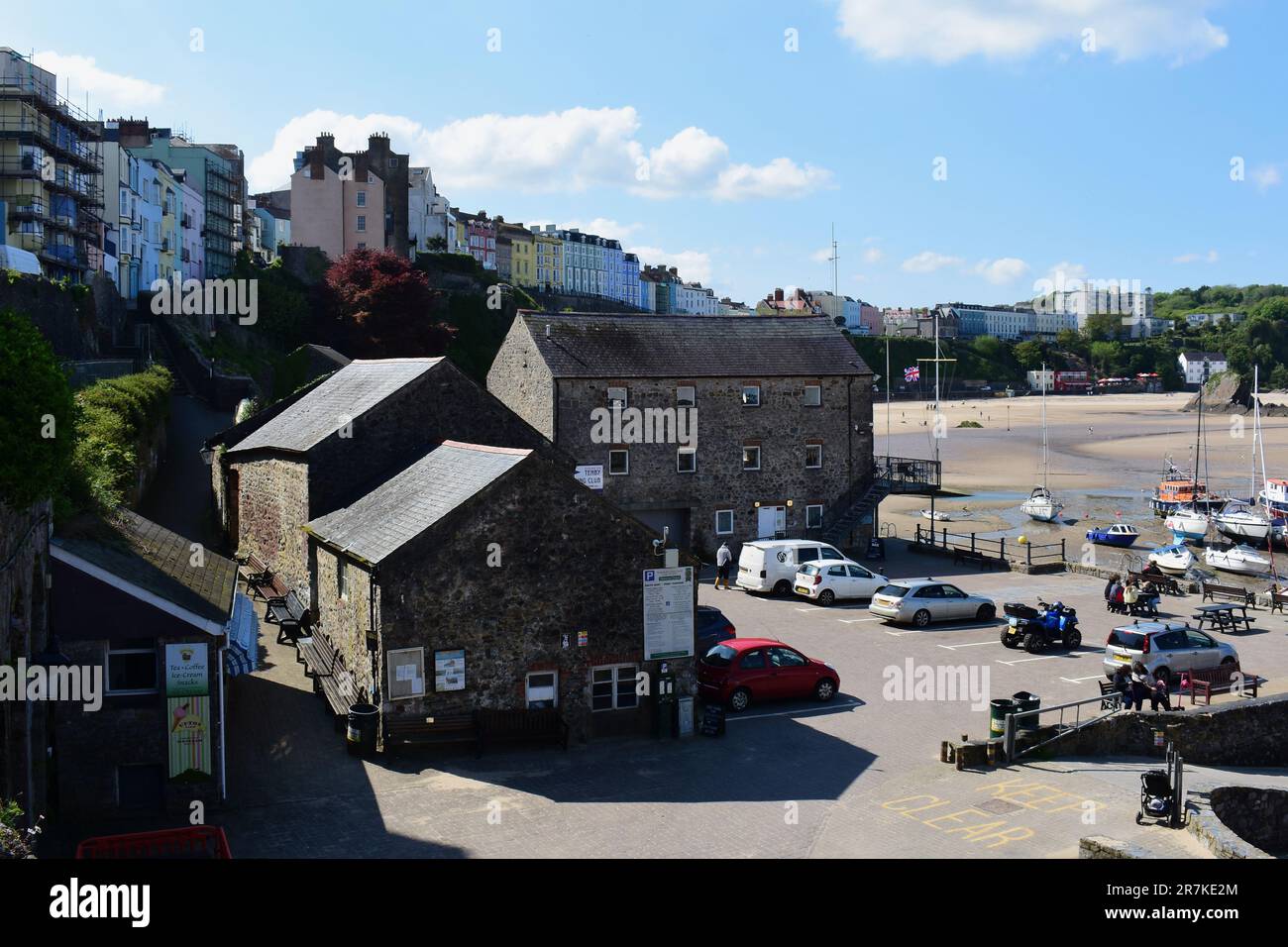 The view across Tenby harbour at low tide with North beach in the ...