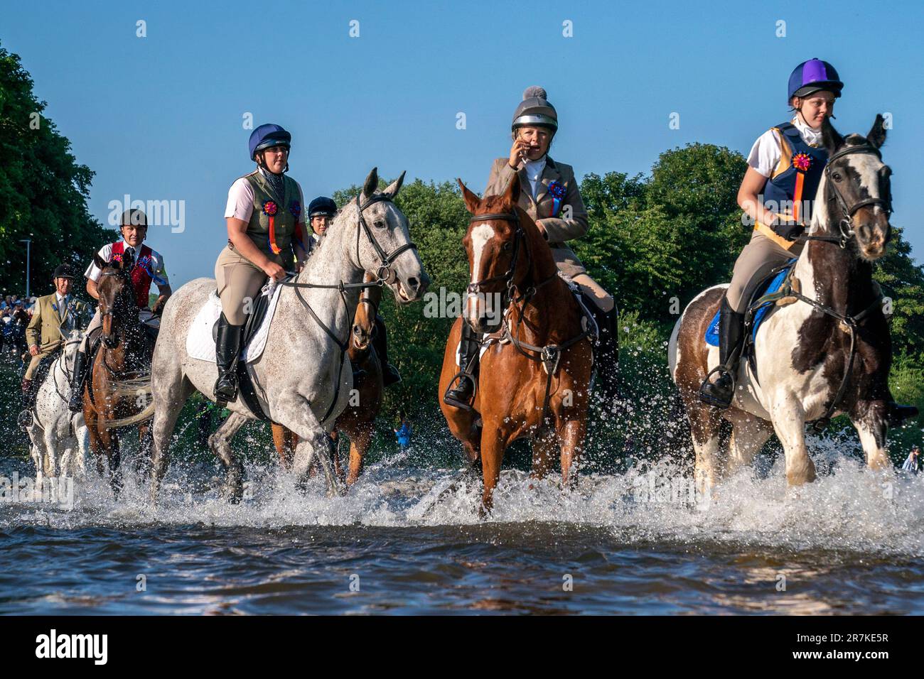 A rider uses her phone while fording the River Ettrick during the ...