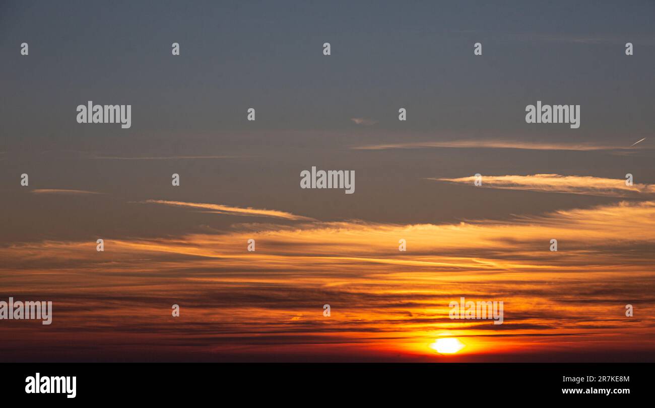 Picture of dramatic and colorful sky with sun during sunset in summer ...