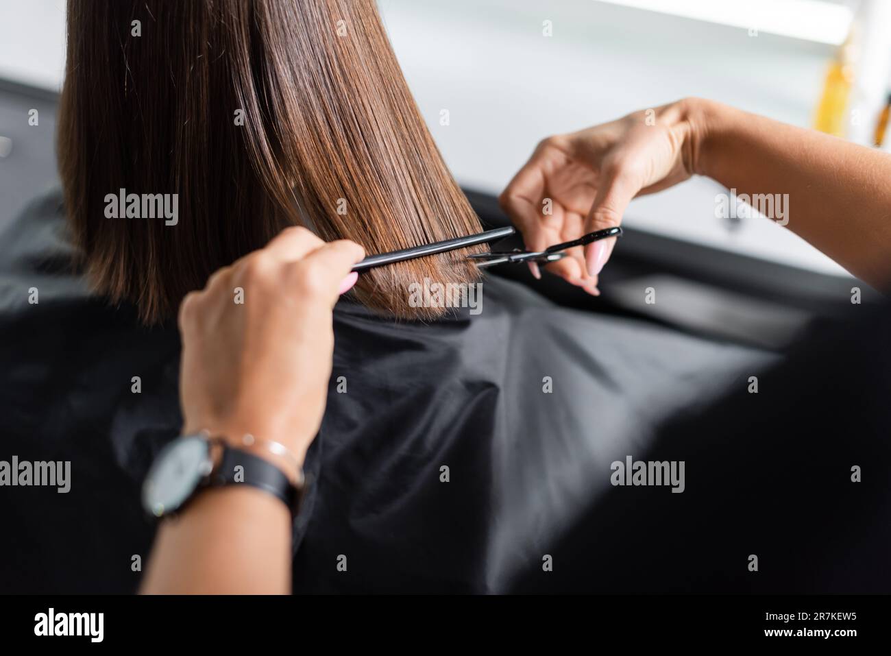 hairdo, cropped view of hairdresser cutting short brunette hair of ...