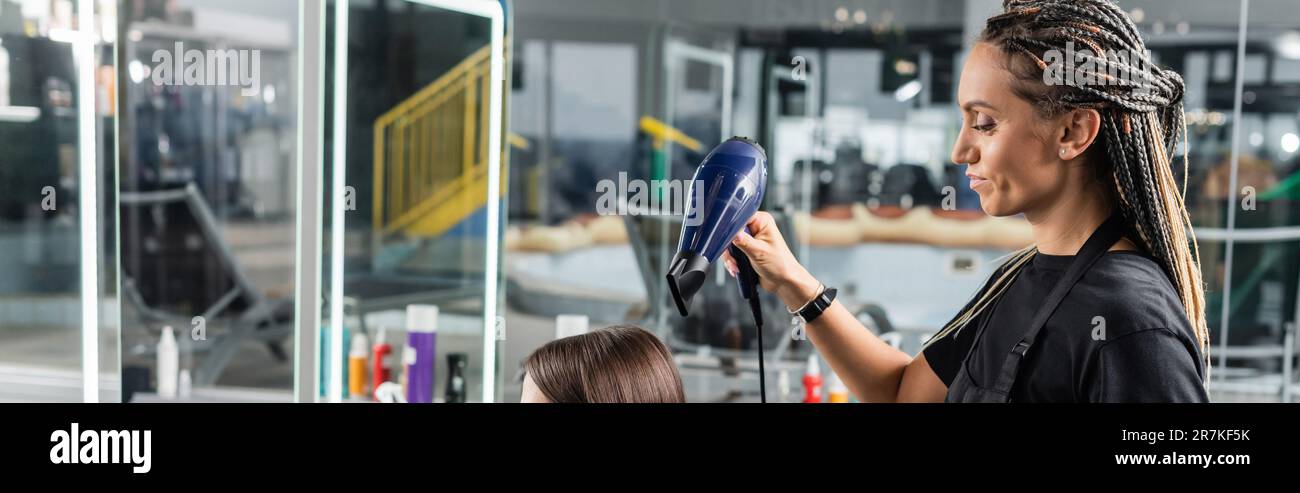 salon blow dry, professional hairdresser with round brush and hair ...