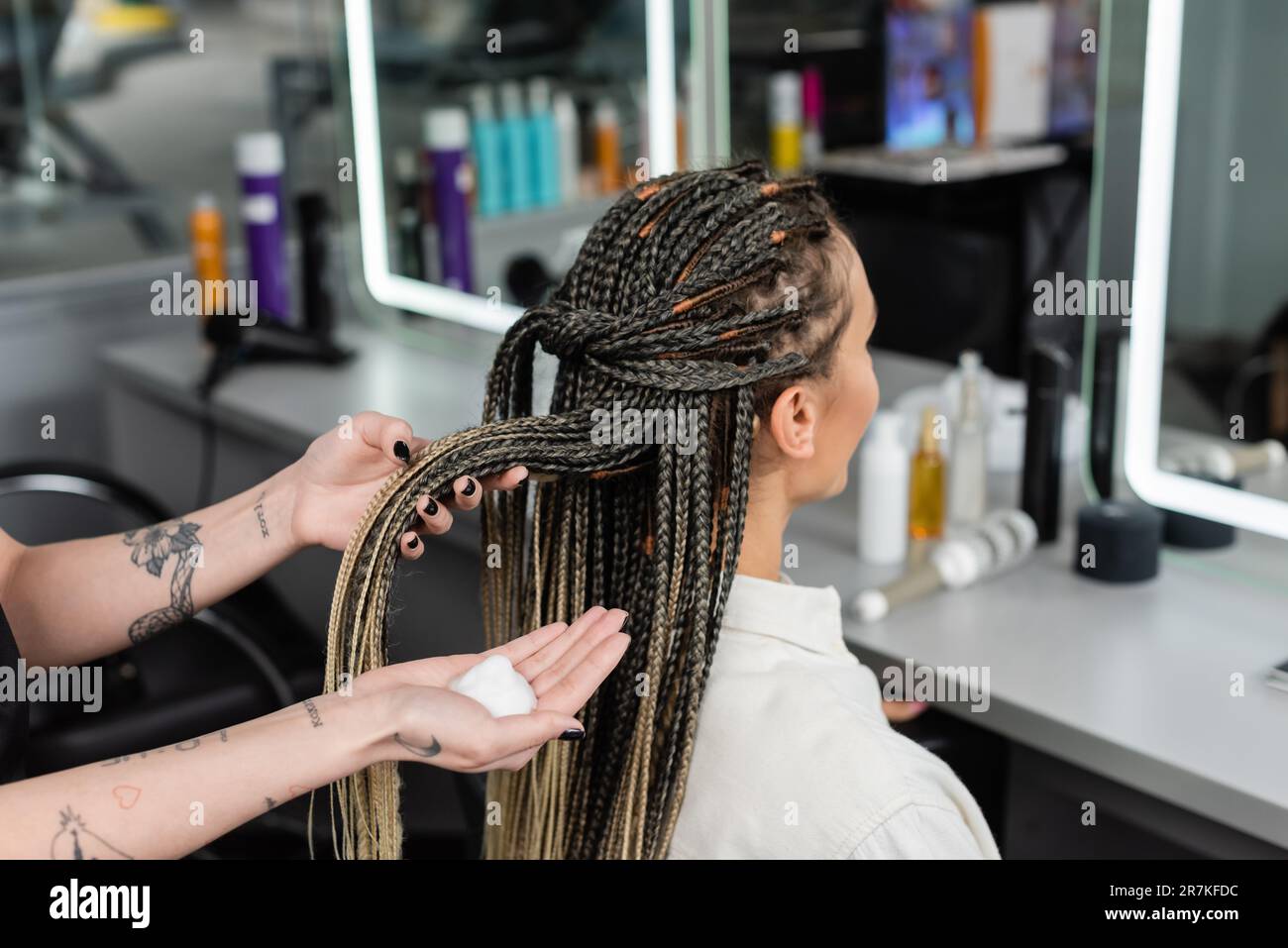 beauty industry, hair product, tattooed hairdresser with styling foam ...