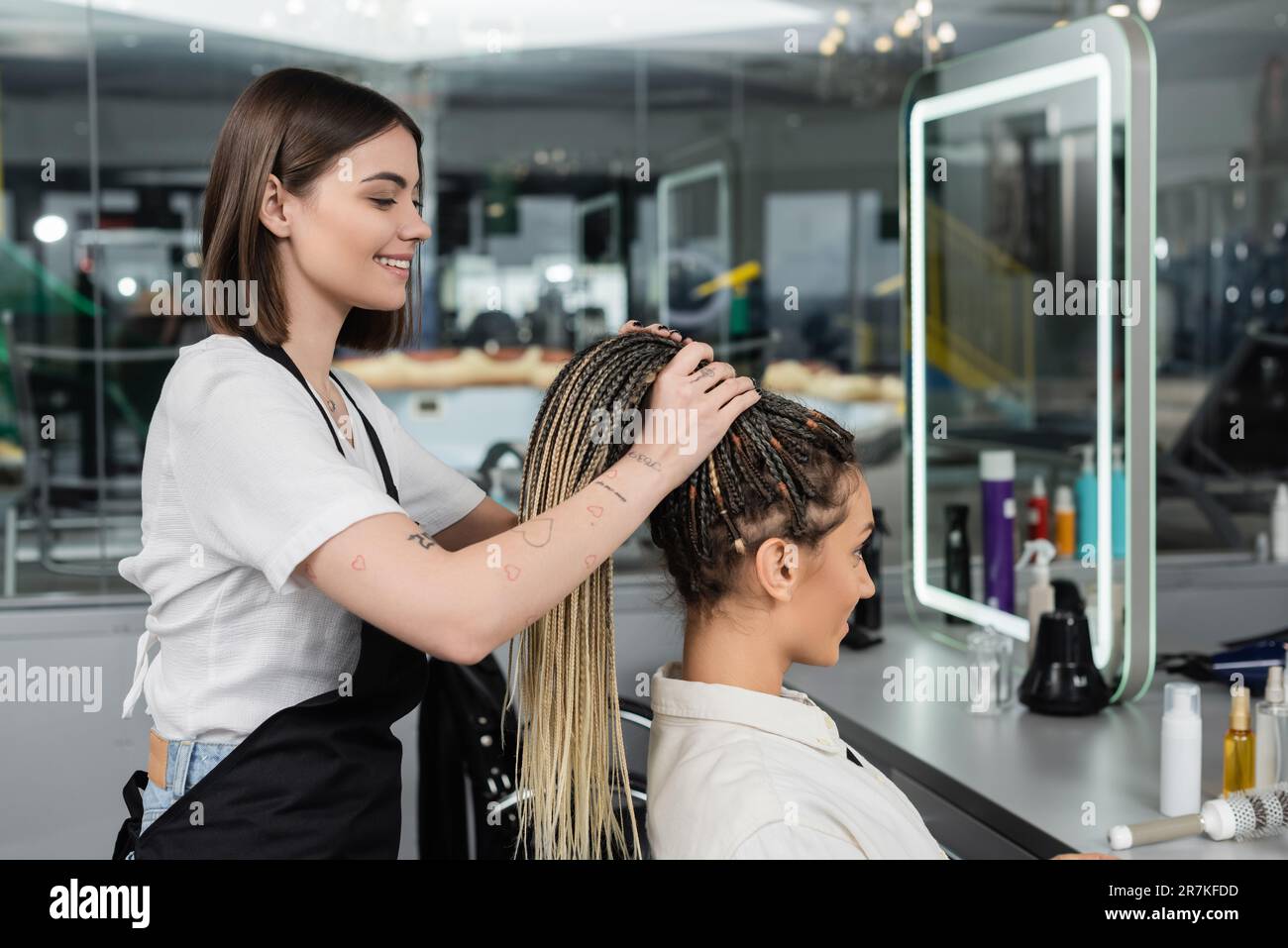 hair make over, cheerful hair stylist lifting hair of female client ...