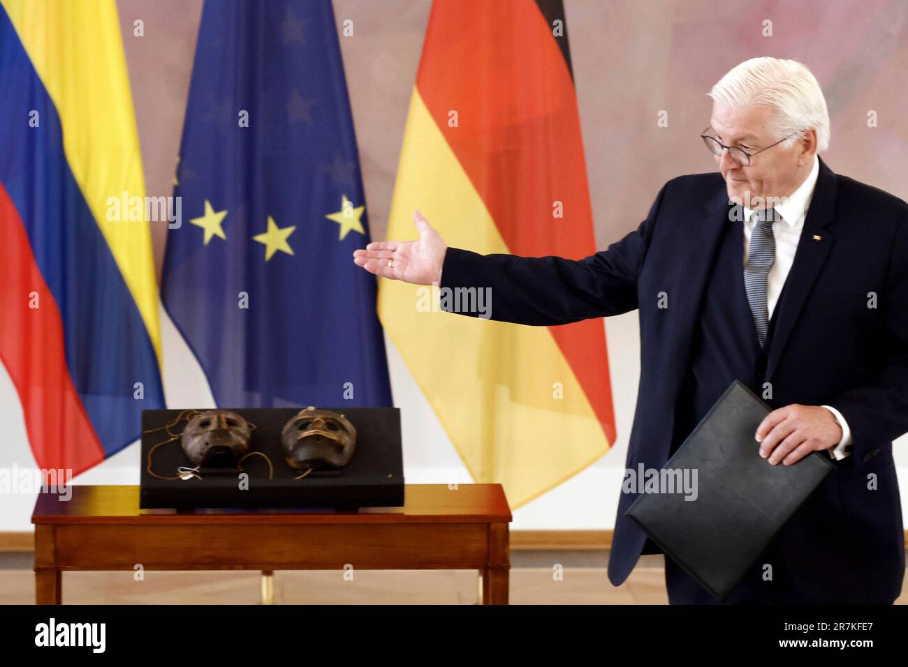 German President Frank-Walter Steinmeier points to two masks of the ...