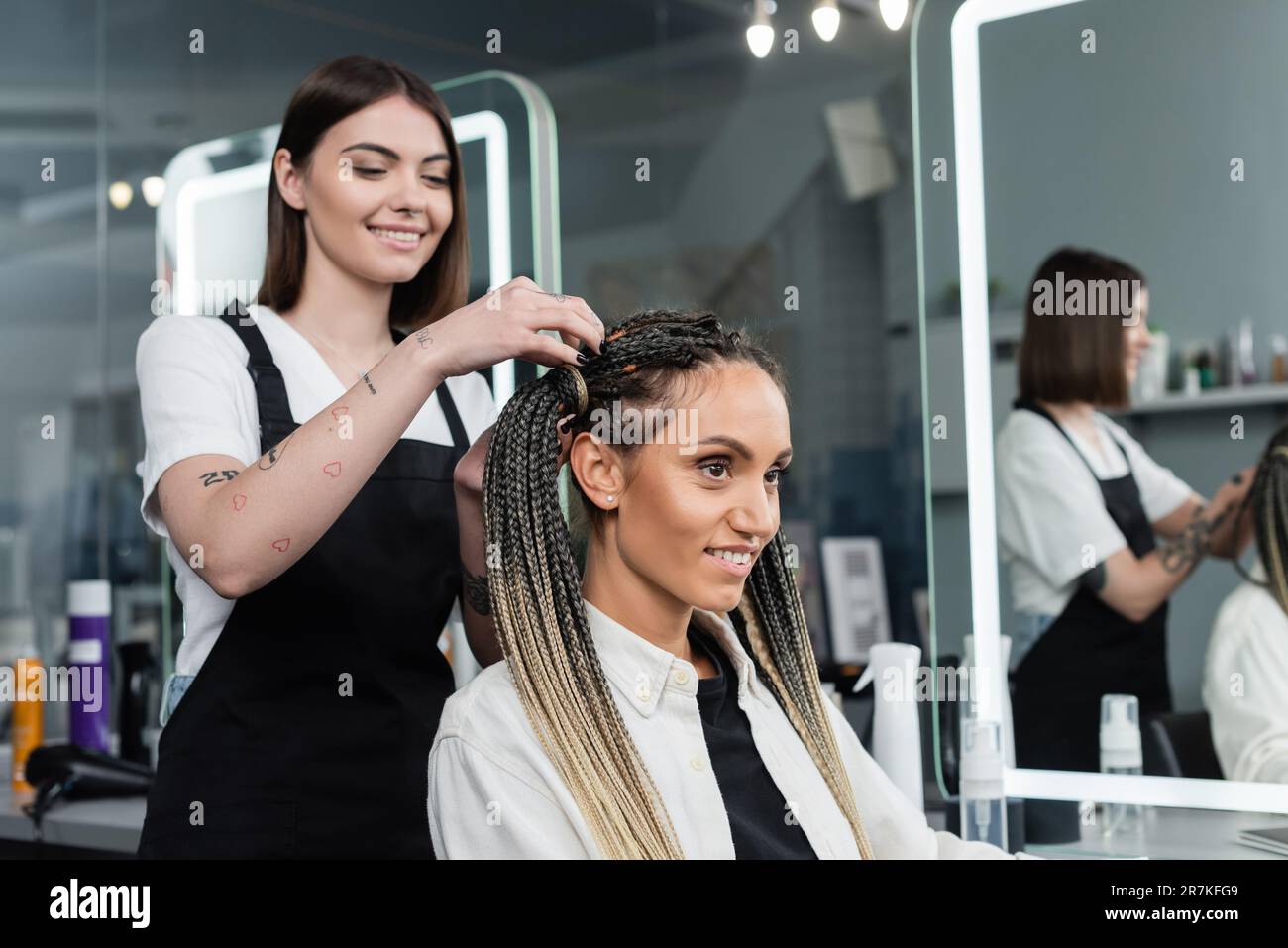 hairdresser and female client, beauty salon, tattooed hair stylist ...