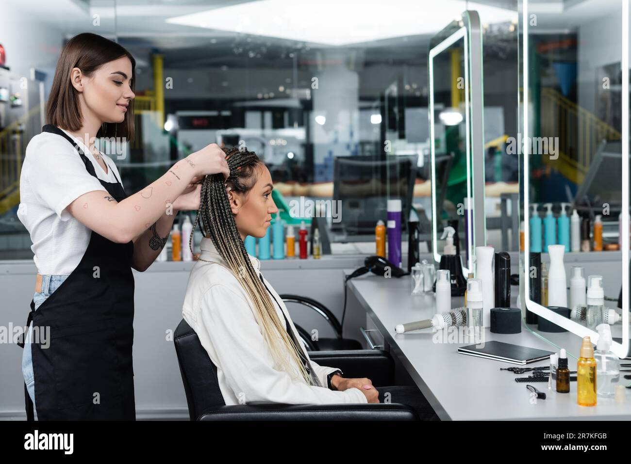 hairdresser and female client, beauty salon, tattooed hair stylist ...