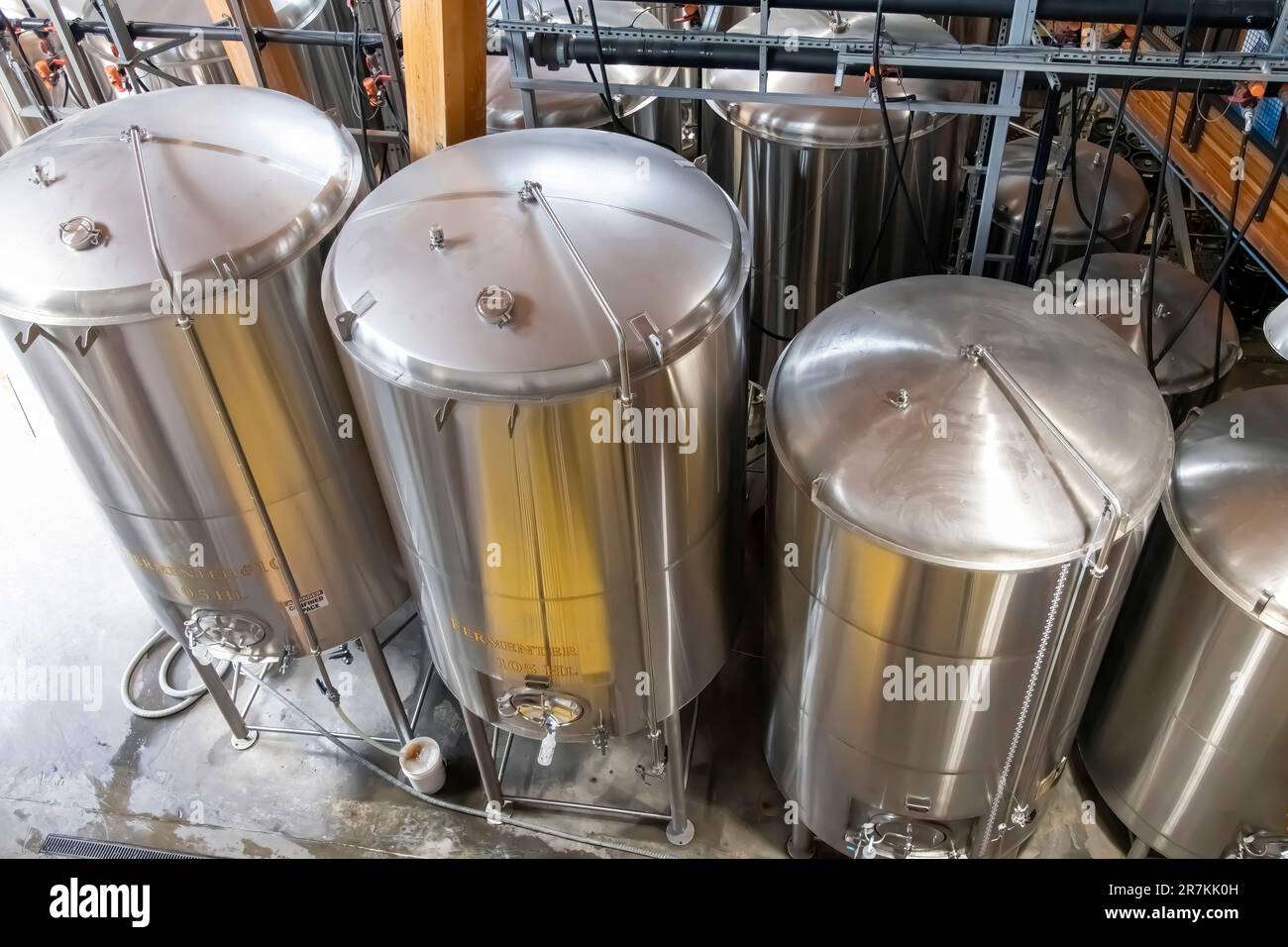 High angle view of some shiny metal tanks and pipework in a beer ...