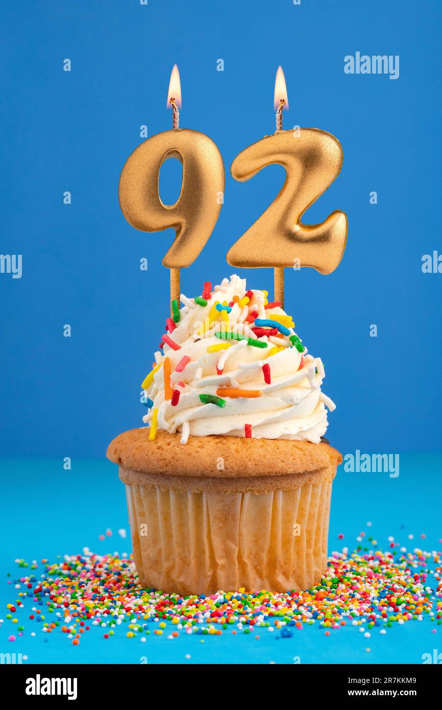 Birthday cake with candle number 92 - Blue background Stock Photo - Alamy