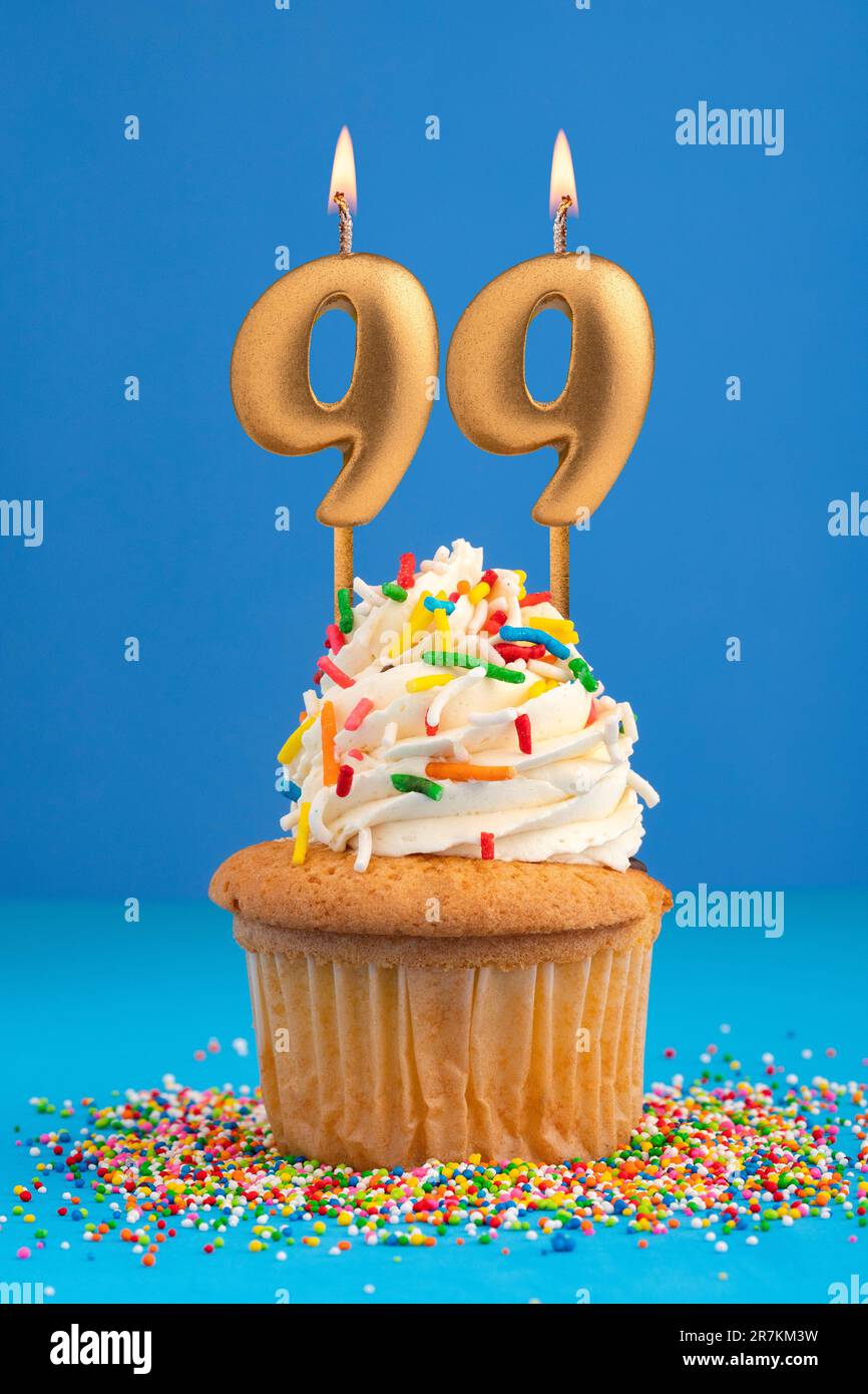 Candle number 99 - Cake birthday in blue background Stock Photo - Alamy