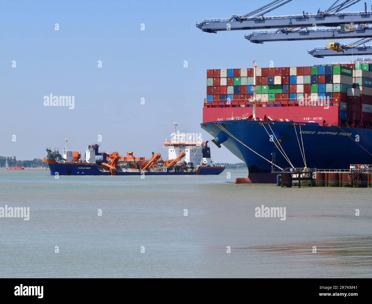 Felixstowe, Suffolk - 16 June 2023 : Dredger passes container ship in ...