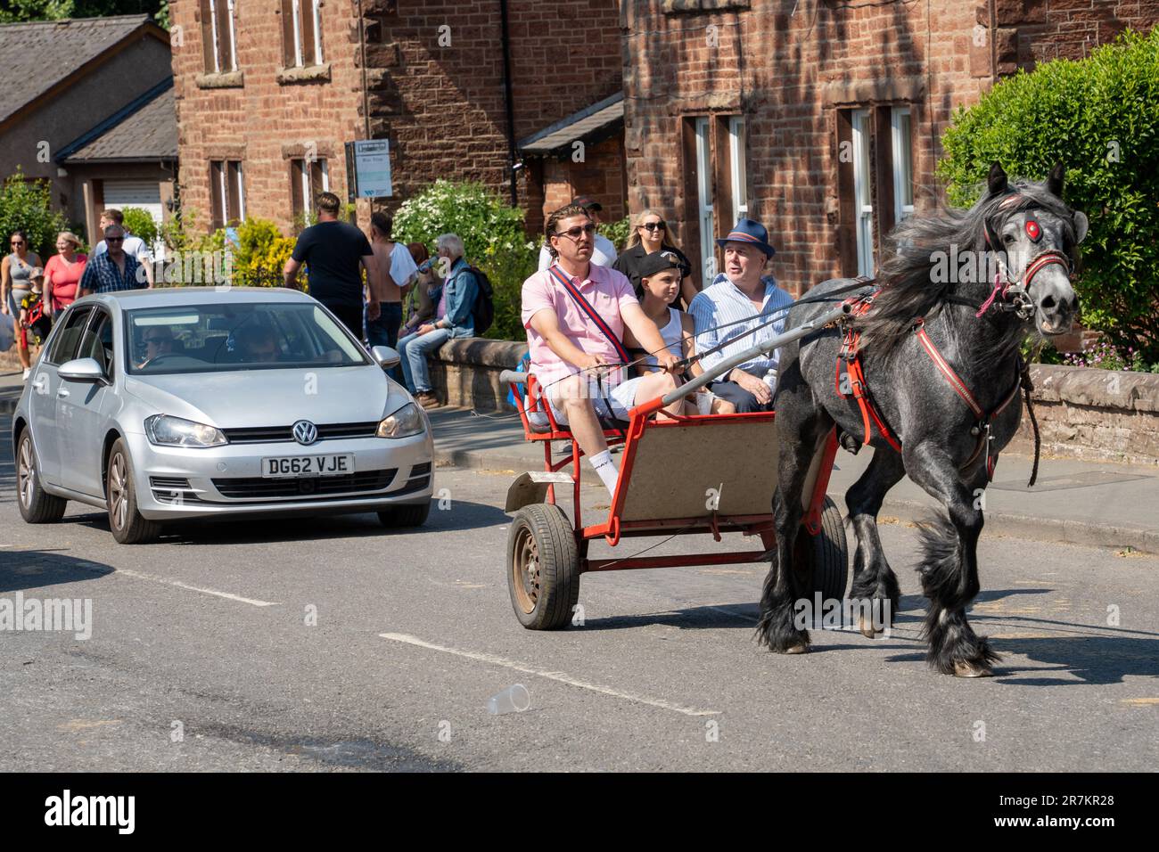 People in a horse drawn exercise cart go along 'The Flashing Lane' at ...