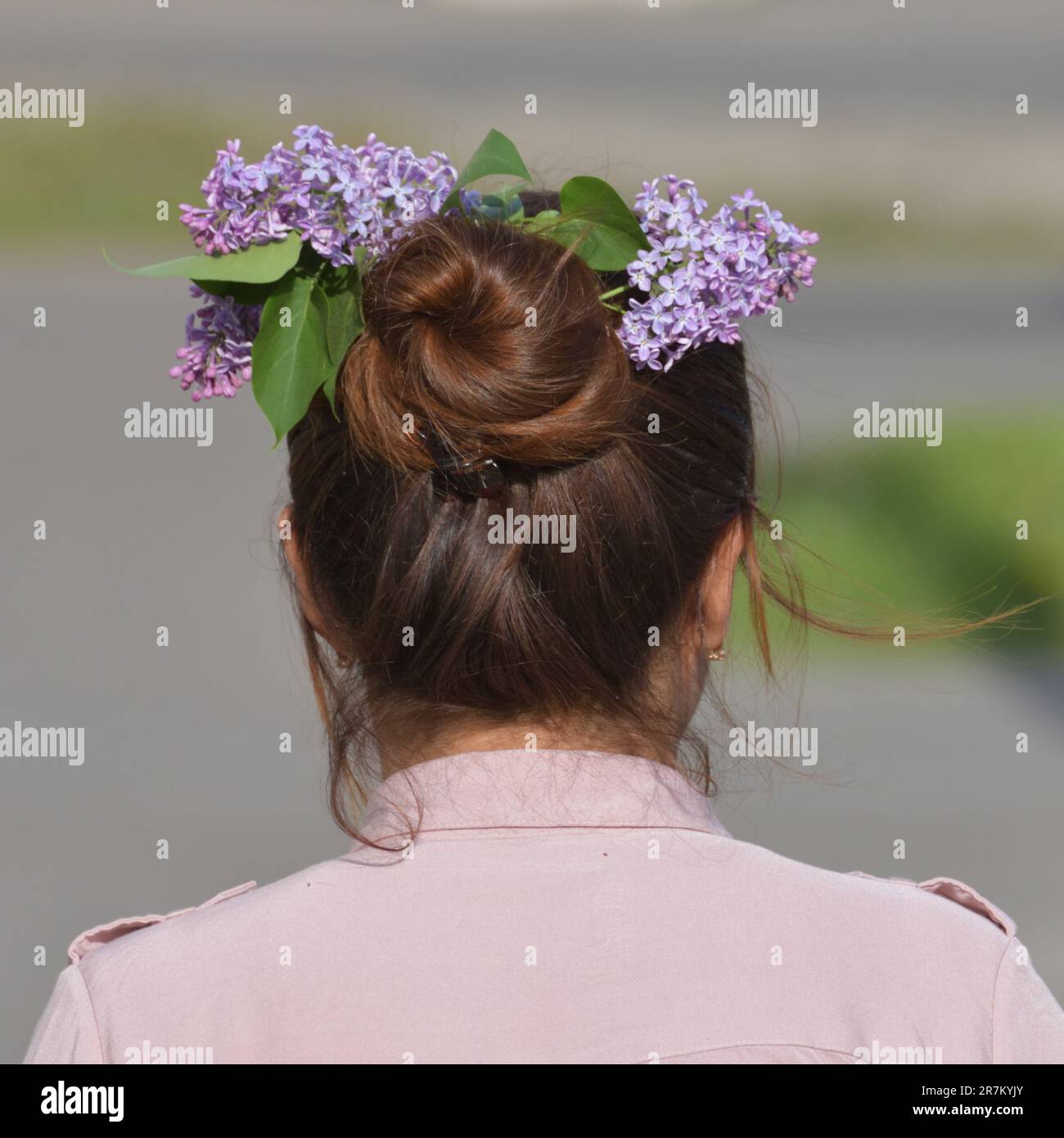 Womens hairstyle with lilac branches. Back view Stock Photo - Alamy