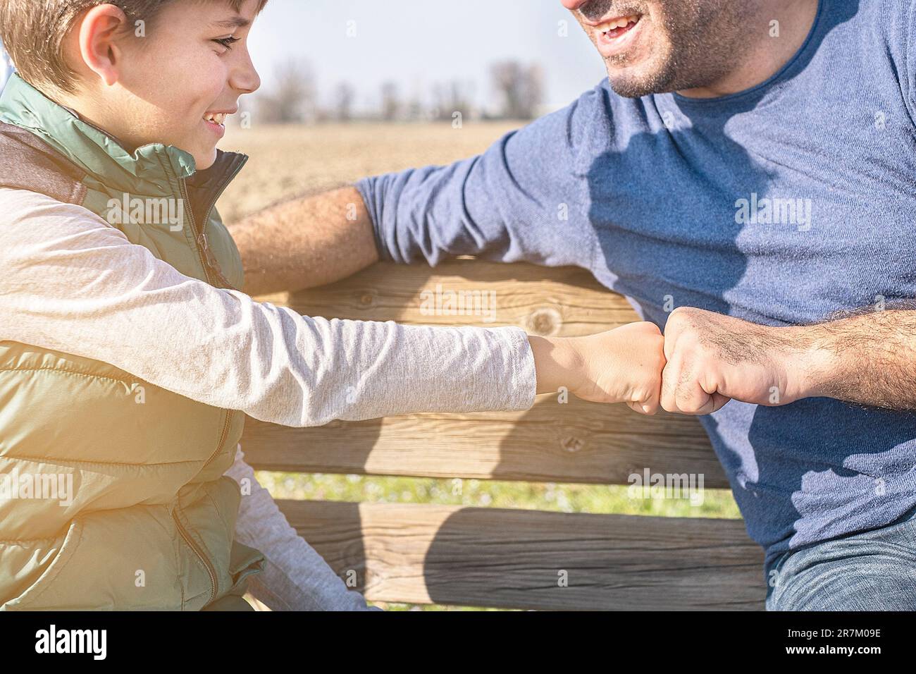 Arms of son and father fist bumping in open space Stock Photo - Alamy