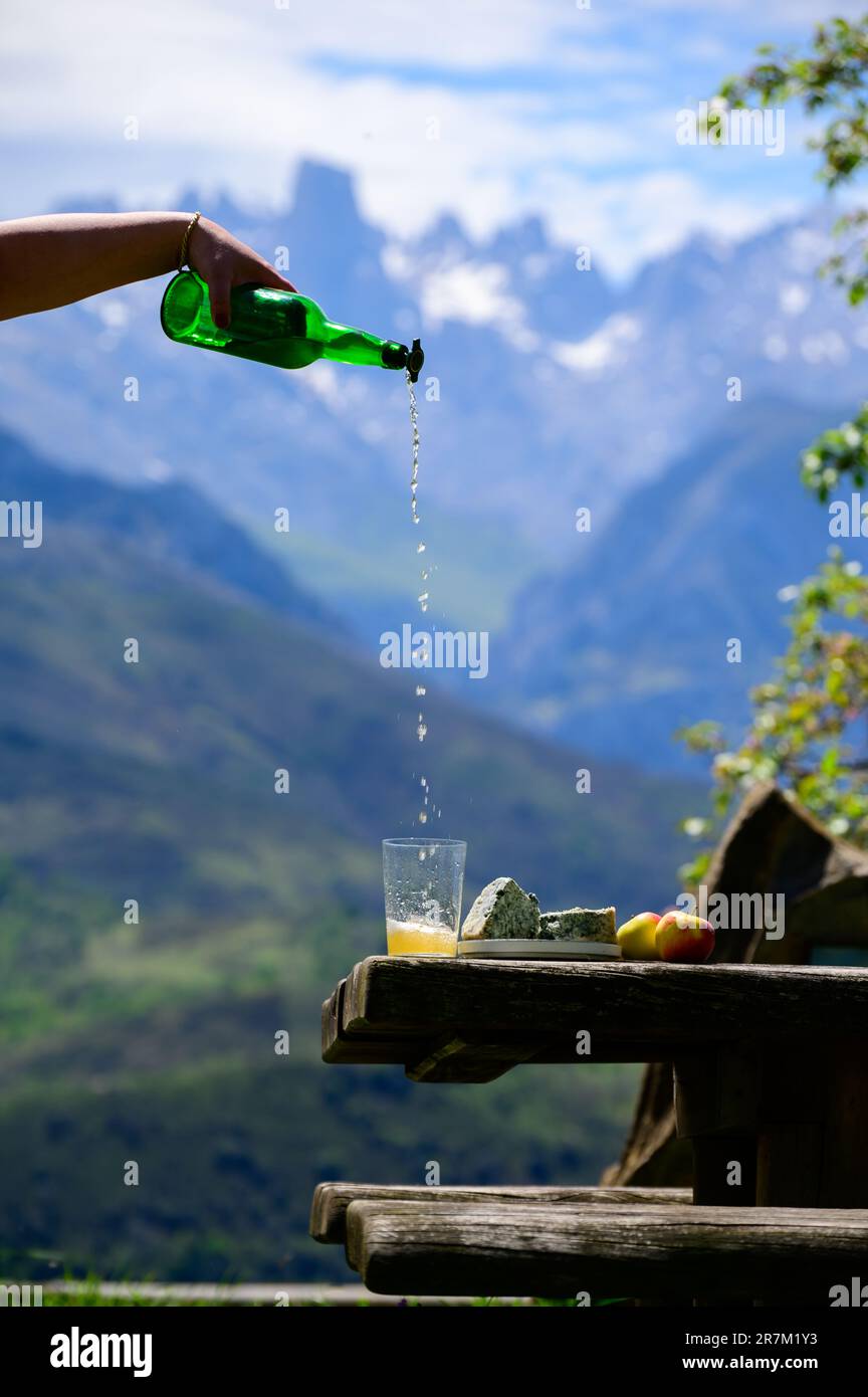 Pouring from high height of natural Asturian cider made from fermented ...