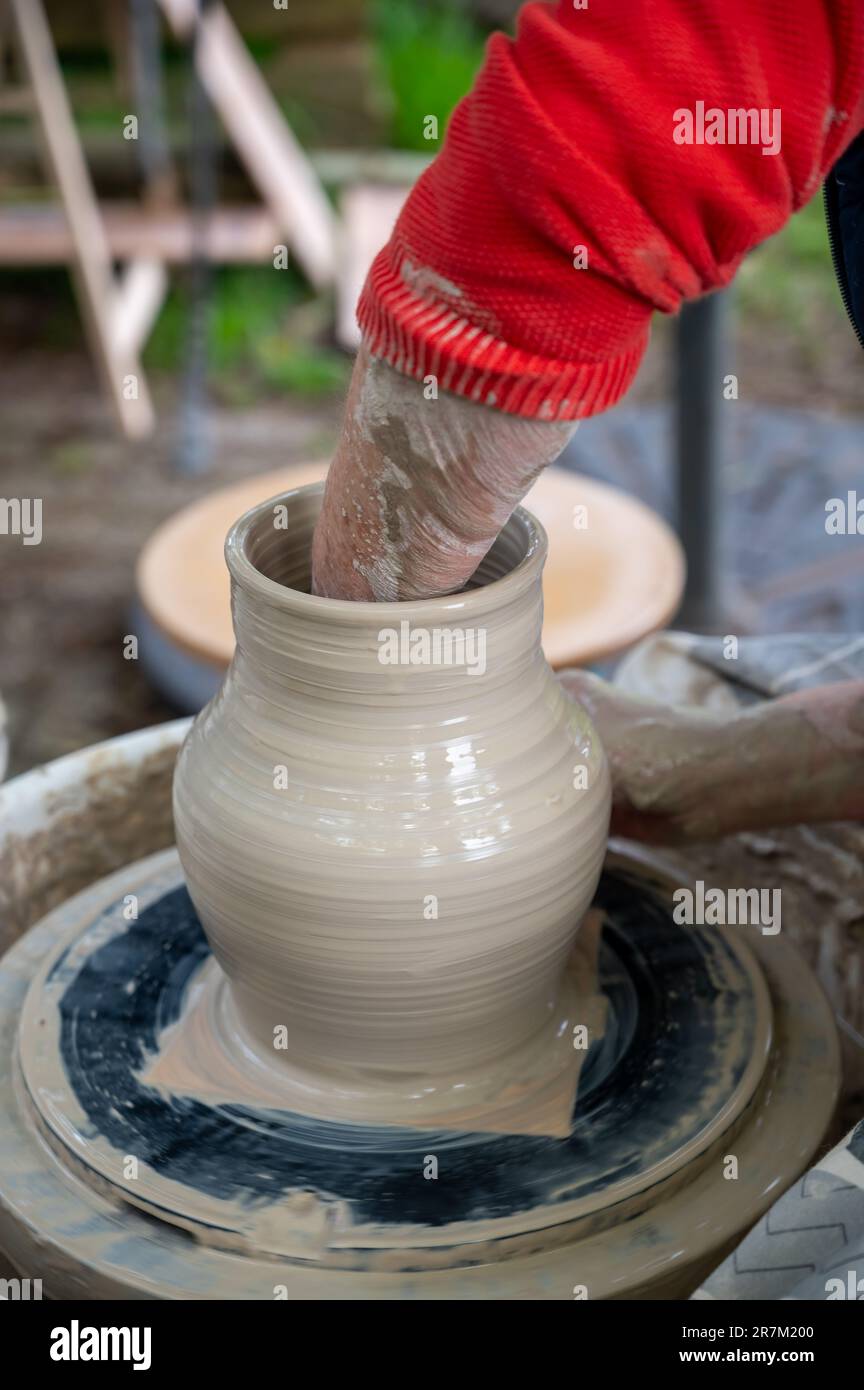 Making of mud pot on potters wheel during workshop outdoor in ...