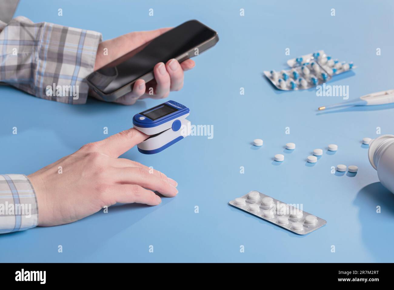 Woman self testing for blood oxygen levels from pulse oximeter Stock ...