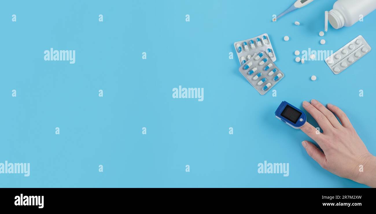 Pulse oximeter on finger to measure pulse rate and blood oxygen ...