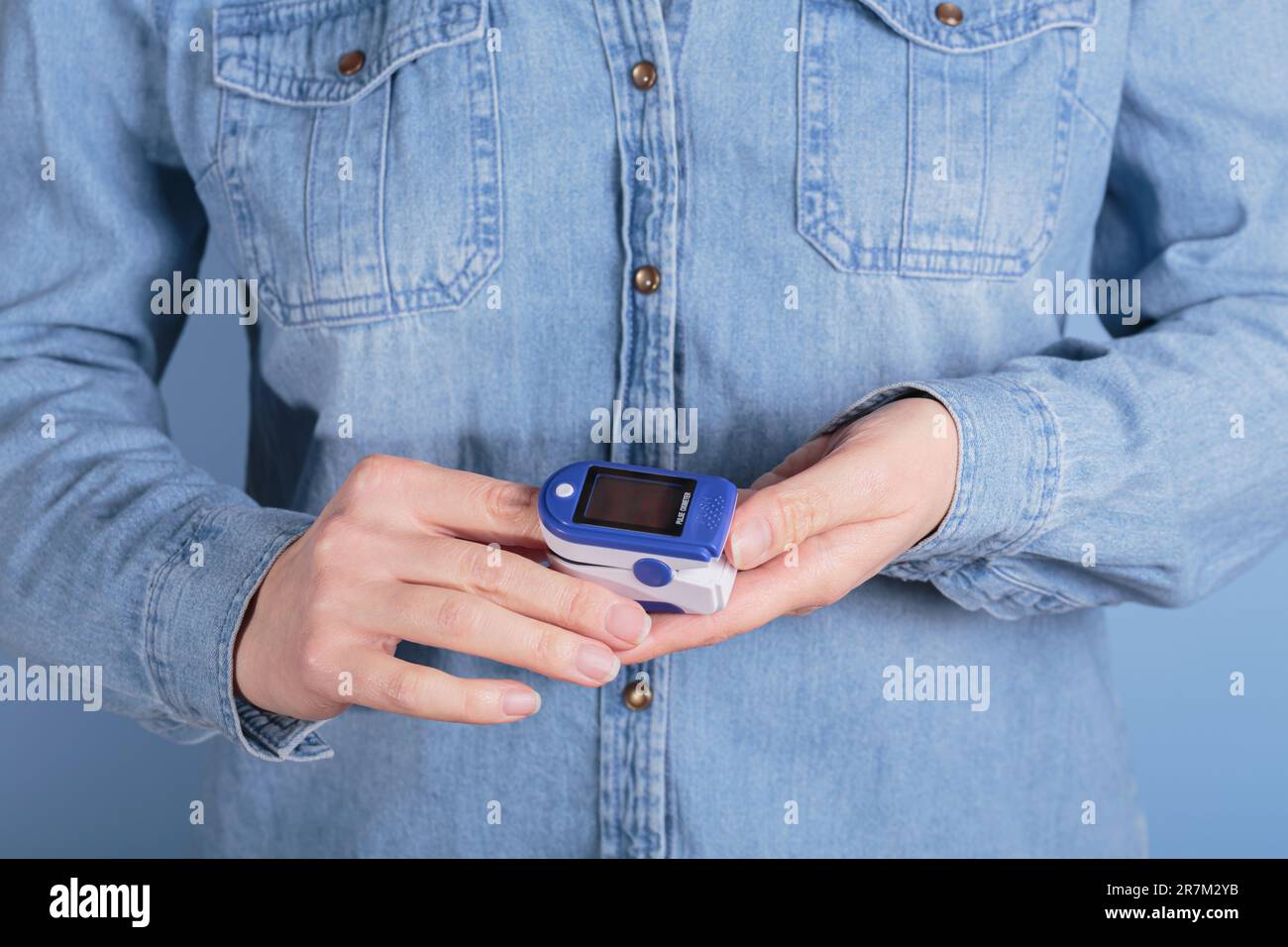 Woman self testing for blood oxygen levels from pulse oximeter Stock ...