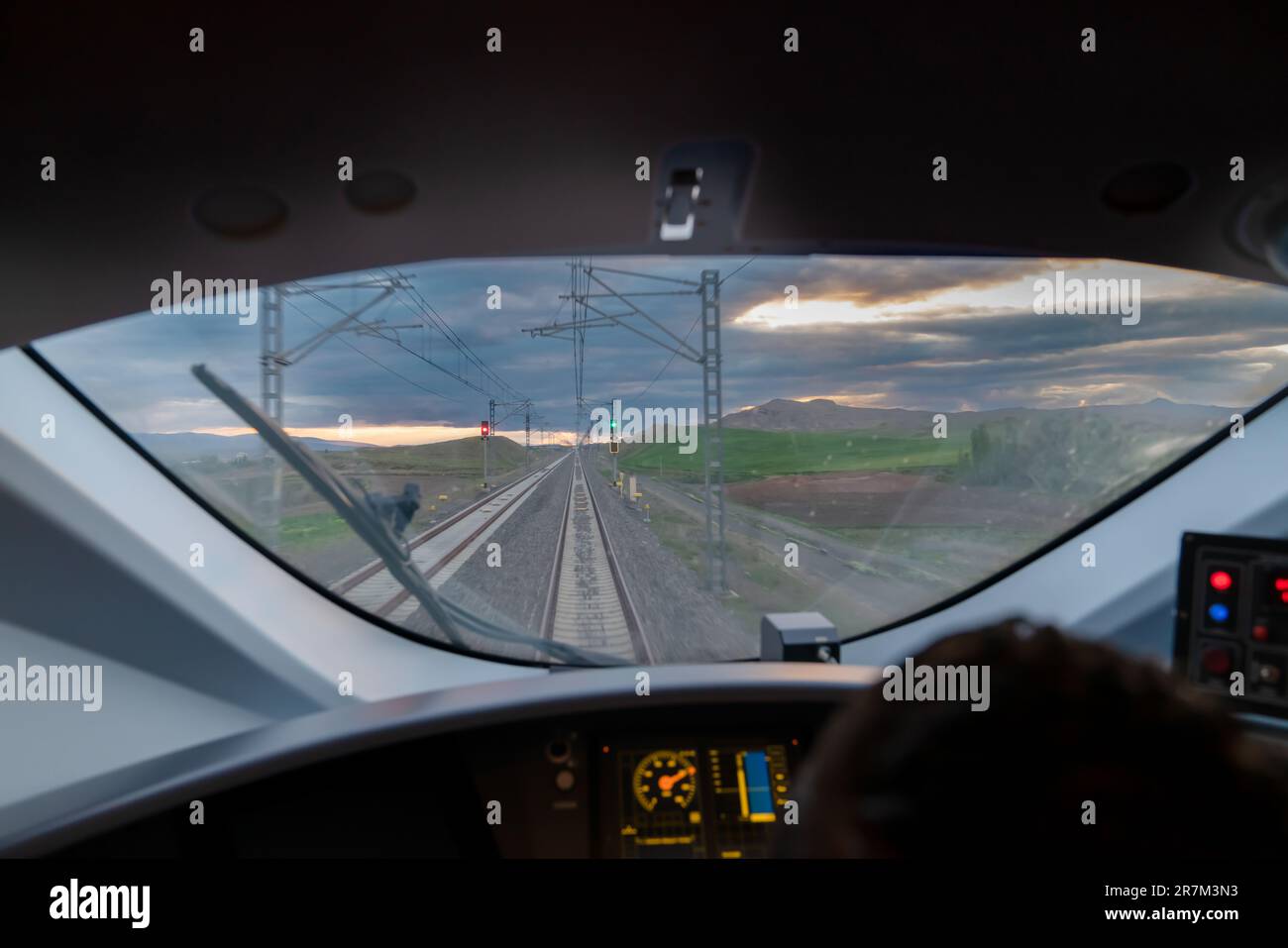 Motion blur view of railway from inside high speed train at evening and ...